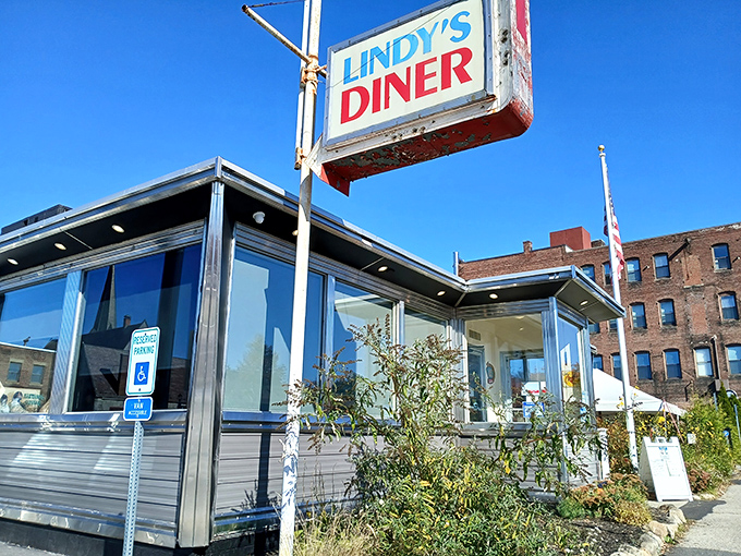 Sunlight bounces off Lindy's chrome exterior like it's auditioning for a Hopper painting, the classic American diner in its natural habitat.