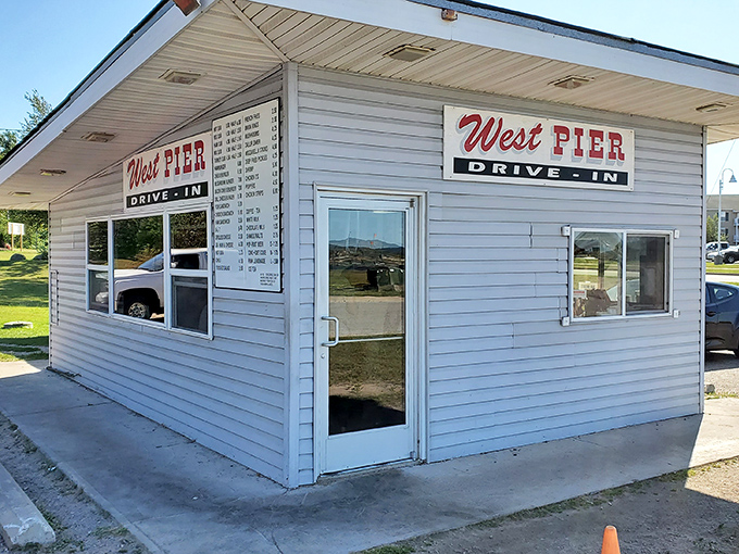 The unassuming white exterior of West Pier Drive-In stands like a culinary lighthouse in Sault Ste. Marie, beckoning hungry travelers with its simple promise of greatness.