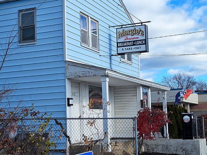 The blue clapboard exterior of Margie's Dream Diner stands like a culinary time capsule, promising comfort food treasures within.