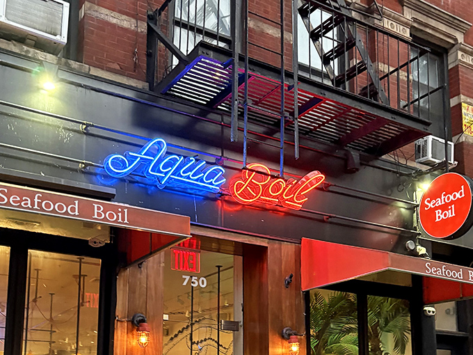 The neon glow of Aqua Boil's sign cuts through Hell's Kitchen's bustle like a lighthouse for hungry seafood lovers seeking their next maritime adventure.