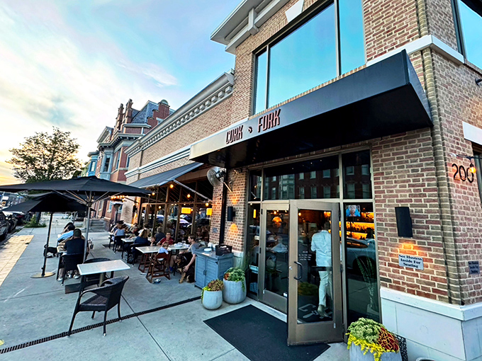 Cork & Fork's inviting brick exterior beckons from its corner spot in Harrisburg, where outdoor tables promise al fresco magic on Pennsylvania evenings.