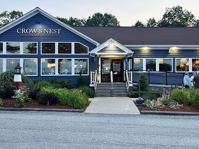 The blue clapboard exterior of Crow's Nest stands like a maritime sentinel, promising seafood treasures within. New England charm personified.