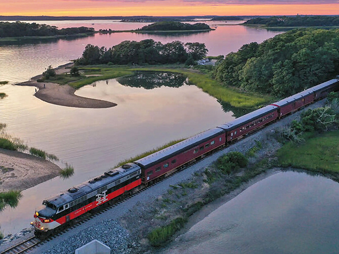 Sunset perfection as the Cape Cod Central Railroad glides alongside marshy inlets. Mother Nature showing off her evening palette while passengers enjoy front-row seats to Cape Cod's hidden coastal treasures.