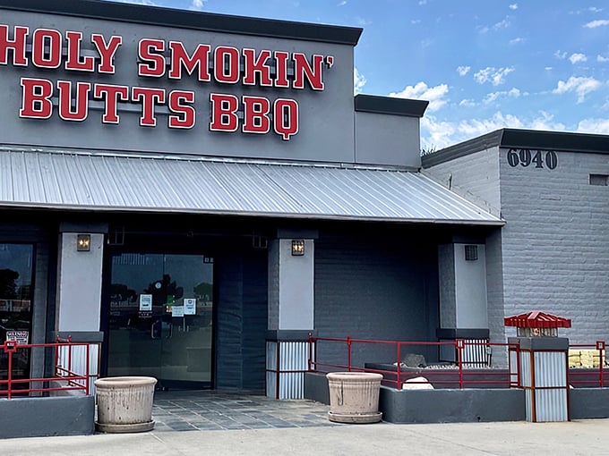 The bold red signage of Holy Smokin' Butts BBQ stands out against the Arizona sky like a beacon for hungry carnivores seeking salvation through smoke.