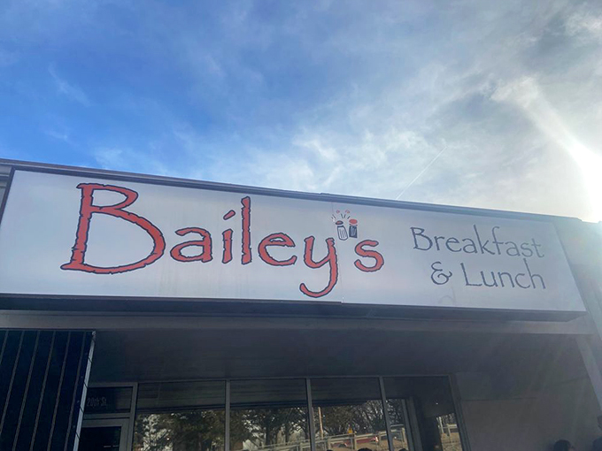 The red lettering of Bailey's sign against the bright Nebraska sky promises comfort food salvation for hungry souls seeking breakfast bliss.