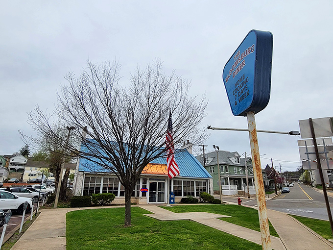 The iconic blue roof of New Bloomsburg Diner stands out like a breakfast beacon, promising comfort food salvation to hungry travelers and locals alike.
