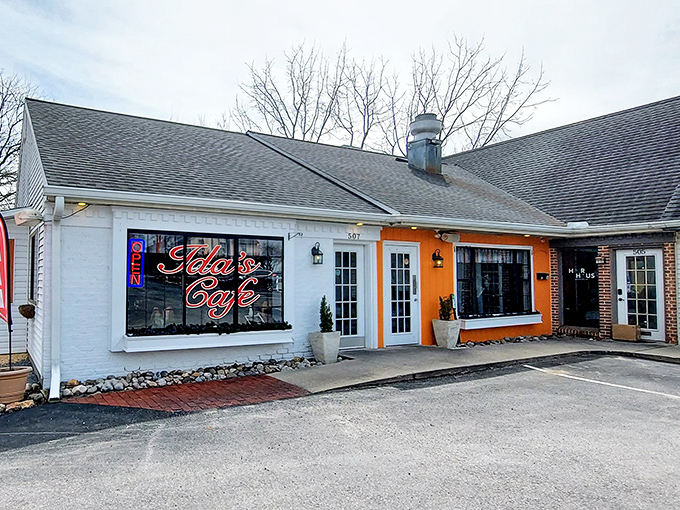 The striking orange accent wall and white trim create that perfect balance of cozy and cheerful &ndash; like a breakfast hug waiting to happen.