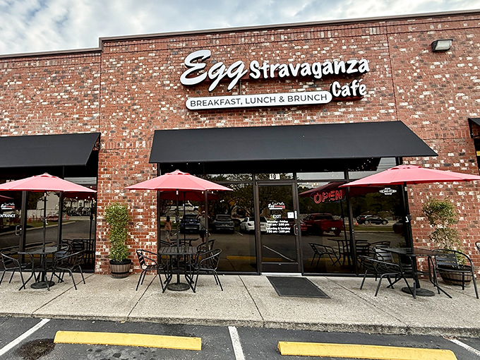 The brick facade of Eggstravaganza Cafe welcomes hungry visitors with its cheerful signage and inviting outdoor seating. A hidden gem in plain sight!