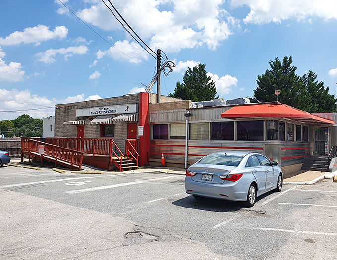 The classic silver-and-red exterior of Tastee Diner stands like a time capsule in Laurel, beckoning hungry travelers with its unmistakable mid-century charm.