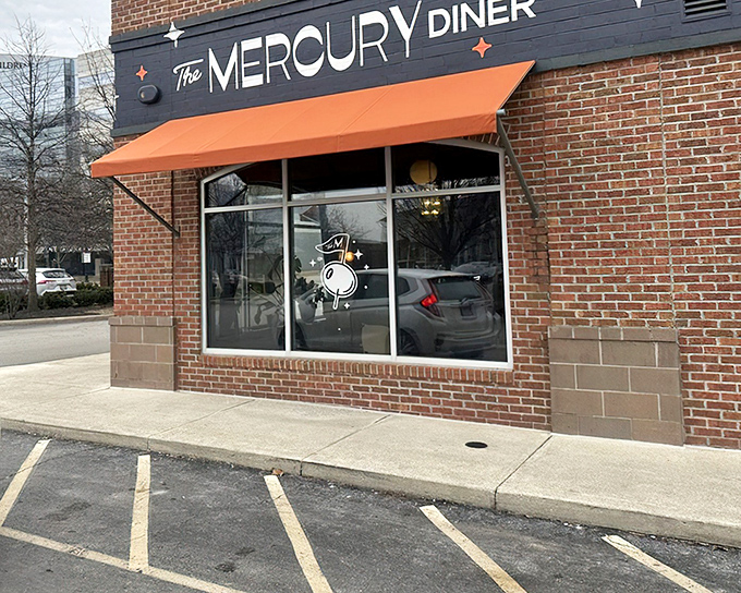 The Mercury Diner's brick exterior with its signature orange awning stands like a beacon for breakfast enthusiasts. Space-age comfort food has found its earthly home.