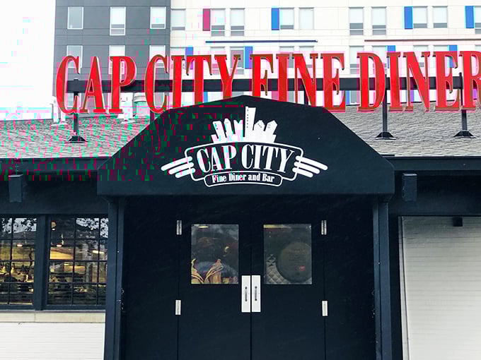 The bold red lettering of Cap City Fine Diner beckons like a neon promise of comfort food nirvana. Classic diner aesthetics with an upscale twist.