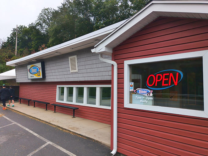 That glowing neon "OPEN" sign isn't just an invitation&mdash;it's a promise of comfort food that awaits inside this roadside haven.