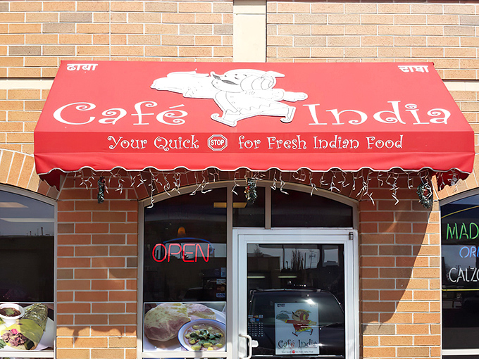 The bright red awning of Cafe India beckons like a culinary lighthouse, promising fresh Indian flavors in an unassuming Milwaukee strip mall.