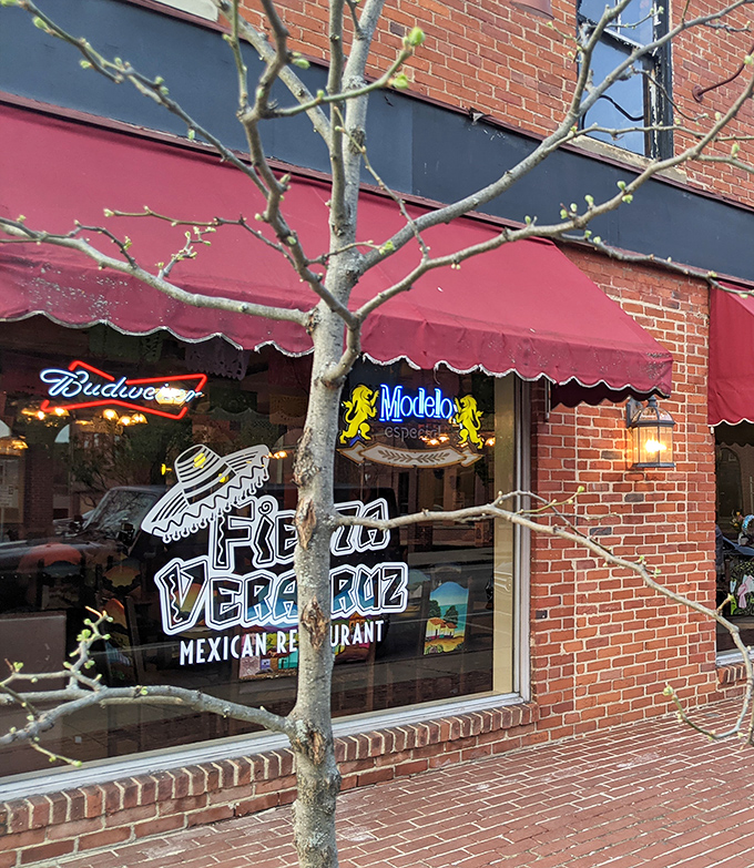 The brick facade and red awning of Fiesta Veracruz might not scream "culinary destination," but that neon Modelo sign is practically winking at you—come inside, it whispers.