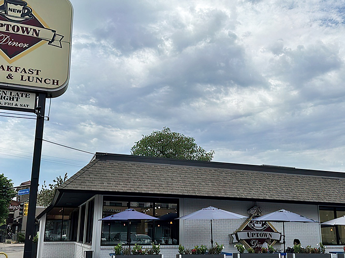The unassuming exterior of Uptown Diner belies the breakfast magic happening inside. Blue skies and comfort food await beneath that modest roof.