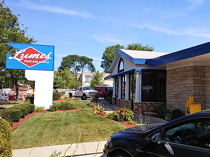 The iconic blue Lumes sign stands like a breakfast lighthouse, guiding hungry Chicagoans to pancake paradise through all seasons.