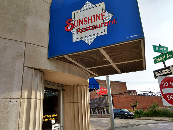 The iconic blue awning and distinctive curved architecture of Sunshine Restaurant stands as a beacon of comfort food in downtown Dubuque, where breakfast dreams come true.