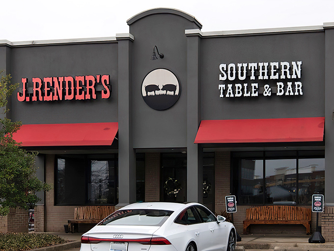 The sleek gray exterior with bold red awnings might not scream "barbecue paradise," but locals know this unassuming facade hides smoky treasures within.