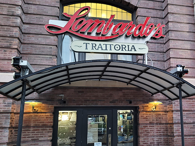 The iconic red script of Lombardo's Trattoria beckons like an old friend against classic St. Louis brick, promising Italian comfort beneath that welcoming awning.