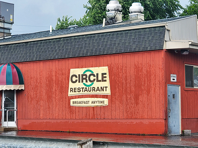The bright red exterior of Circle Restaurant stands like a beacon of breakfast hope, proudly declaring "BREAKFAST ANYTIME" &ndash; words that warm the soul.