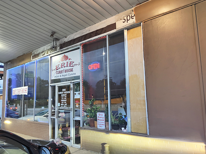 The unassuming storefront of Erie Curry House beckons with its simple red logo and glowing "OPEN" sign&mdash;culinary treasures often hide in plain sight.