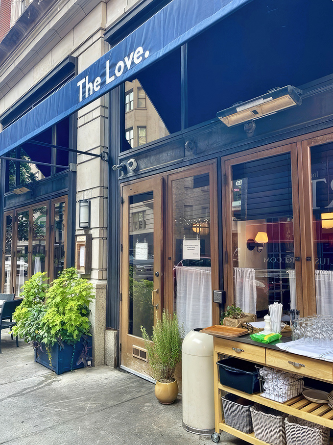 The Love's inviting blue awning and wooden doors welcome you to Philadelphia's hidden gem, where hush puppy dreams come true.