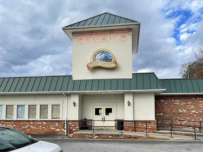 The iconic "STEAKS" sign glows like a beacon for hungry travelers. This unassuming exterior hides a treasure trove of culinary delights within.