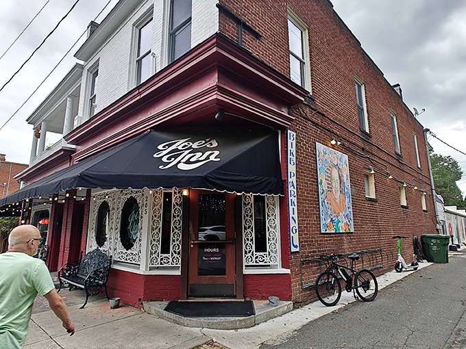 The iconic corner brick building with its distinctive burgundy trim and black awning has welcomed Richmond diners for generations, standing as a beacon of comfort in the Fan District.