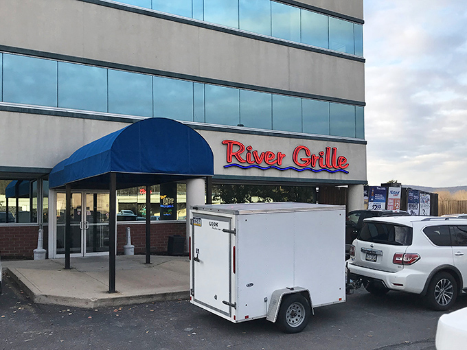 The iconic blue awning and glowing red sign of River Grille beckons like a lighthouse for hungry souls navigating the streets of Wilkes-Barre.