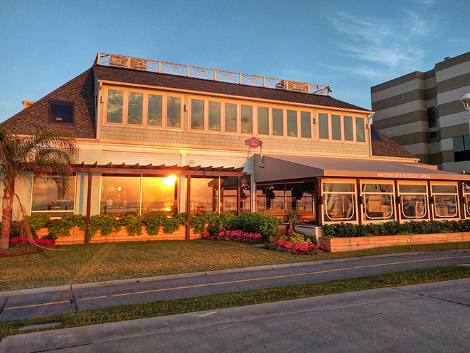 Sunset transforms Waterman's into a coastal postcard come to life, with its shingle siding and expansive windows framing the approaching evening.