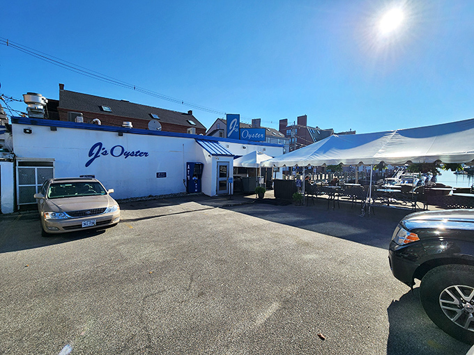 Sun-drenched perfection at J's Oyster, where outdoor seating beckons seafood lovers to savor Maine's maritime treasures under clear blue skies.