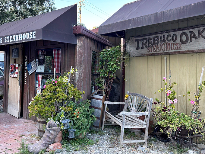 The rustic charm of Trabuco Oaks Steakhouse welcomes you like an old friend, complete with weathered bench and boot-shaped planters that scream "leave your fancy pants at home."