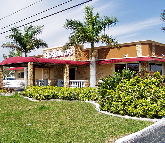 Florida sunshine meets classic steakhouse charm. The red awnings and lush landscaping create that perfect "I've found a hidden gem" moment.