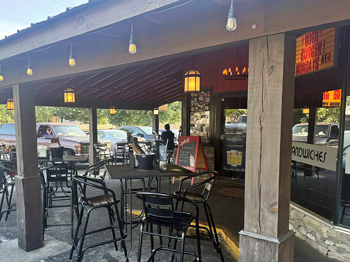 A covered patio area offers the perfect spot for al fresco dining, where string lights and lanterns create a warm, inviting atmosphere.