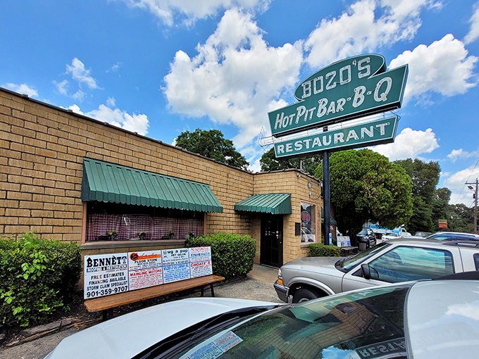 The iconic teal sign of Bozo's Hot Pit Bar-B-Q stands like a beacon of hope for hungry travelers. This unassuming brick building houses barbecue treasures worth a detour.
