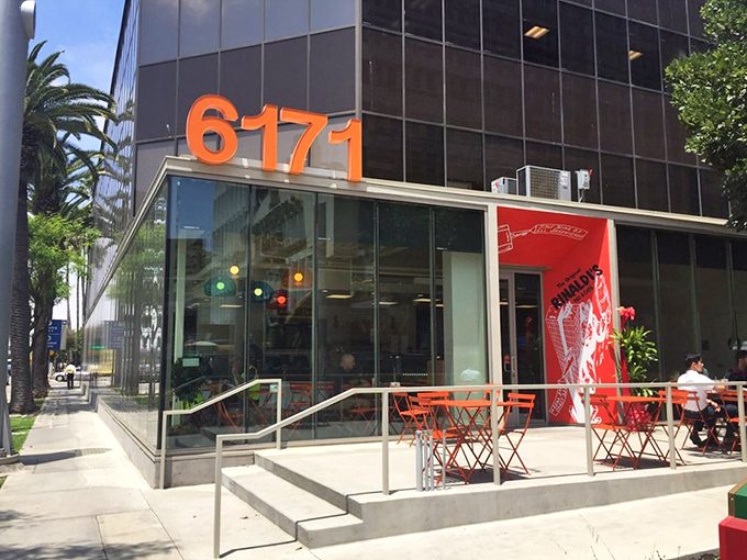 The modern glass exterior with bright orange "6171" signage promises what lies within: sandwich nirvana waiting to be discovered.