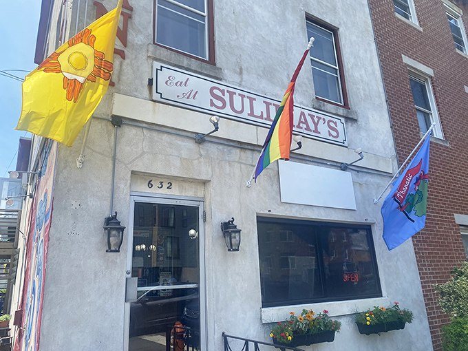 The classic "Eat At Sulimay's" sign beckons hungry travelers like a lighthouse for breakfast enthusiasts. Those colorful flags aren't just decoration&mdash;they're surrender flags from defeated appetites.
