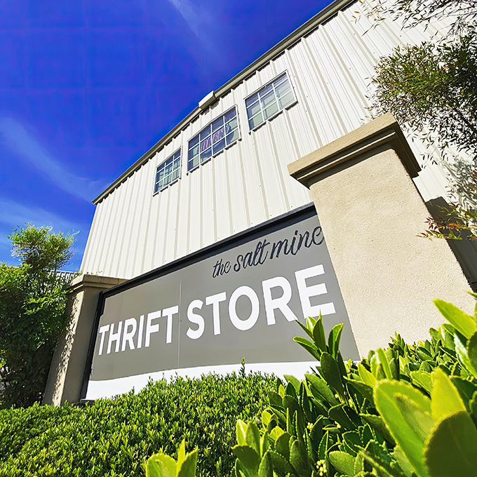 The unassuming exterior of The Salt Mine Thrift Store stands against a brilliant blue California sky, promising treasures within its metal walls.