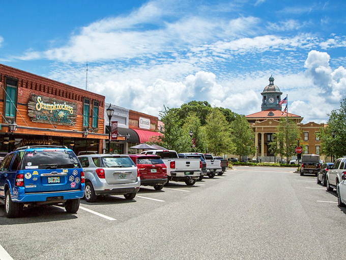 Downtown Inverness captures small-town Florida charm at its finest, where Stumpknockers restaurant meets historic architecture under perfect blue skies.