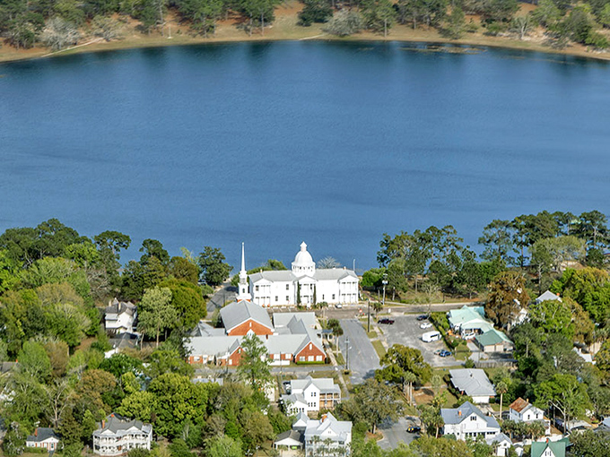 Lake DeFuniak shimmers like a perfect blue coin dropped from heaven, surrounded by historic homes and lush greenery &ndash; Florida's hidden circular gem.