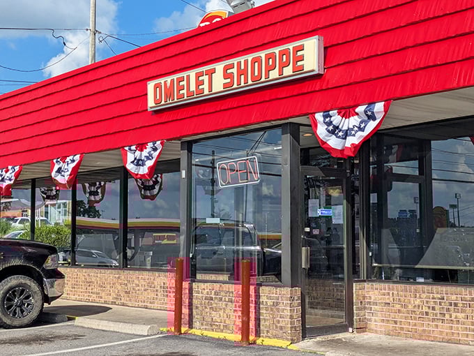 The bright red awning of Omelet Shoppe stands out like a breakfast beacon, promising morning salvation to hungry travelers passing through Beckley.