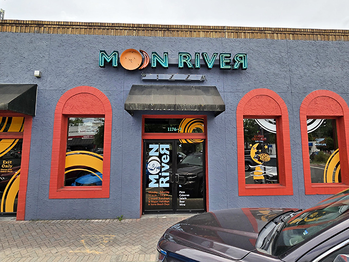 Daylight reveals Moon River's cheerful exterior, where the bright red-trimmed windows frame glimpses of pizza paradise waiting inside.