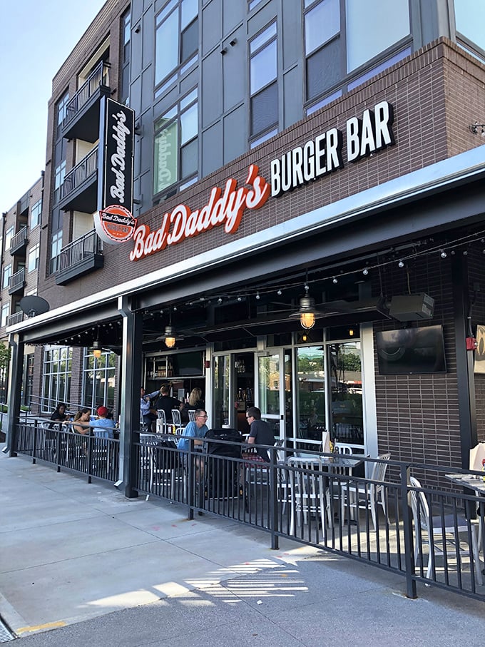 The glowing red neon sign beckons like a lighthouse for the hungry and burger-deprived. Modern brick meets classic comfort food promise.