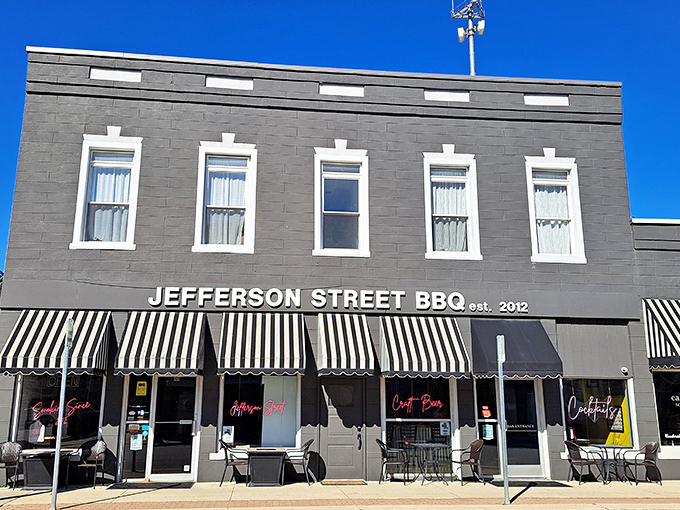 The unassuming brick facade of Jefferson Street BBQ in Converse hides culinary treasures within. Those classic striped awnings practically whisper, "Come in, the brisket's waiting."