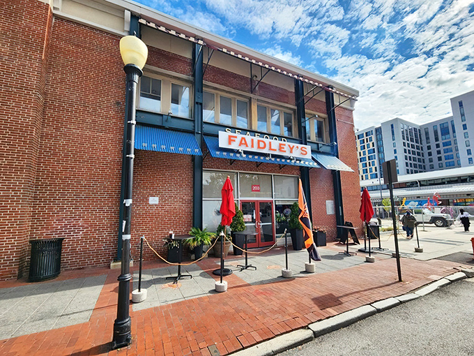 The brick facade of Faidley's stands like a culinary lighthouse, beckoning seafood pilgrims with its iconic blue awning and bold red signage.