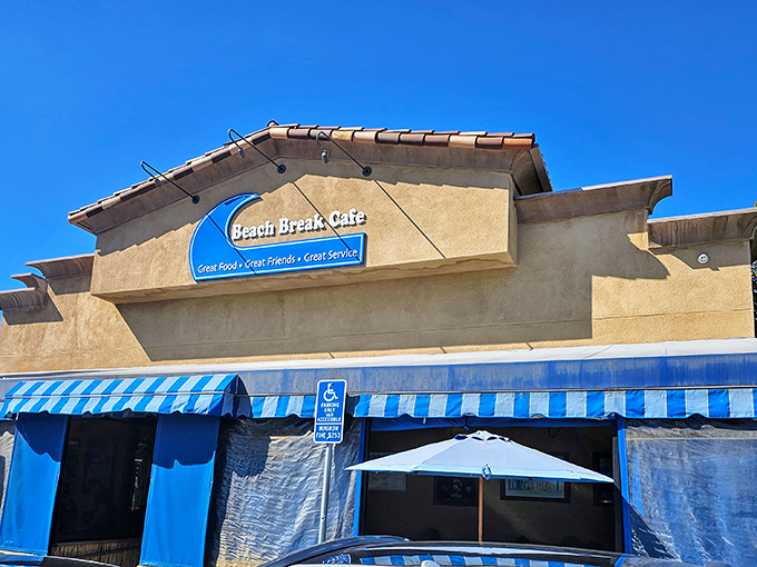 The iconic blue awning of Beach Break Cafe beckons like a lighthouse for hungry souls. This corner of coastal paradise has saved many a morning.