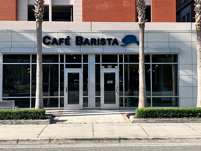 The unassuming storefront of Café Barista stands like a culinary speakeasy, flanked by palm trees that seem to whisper, "Yes, this is the place."