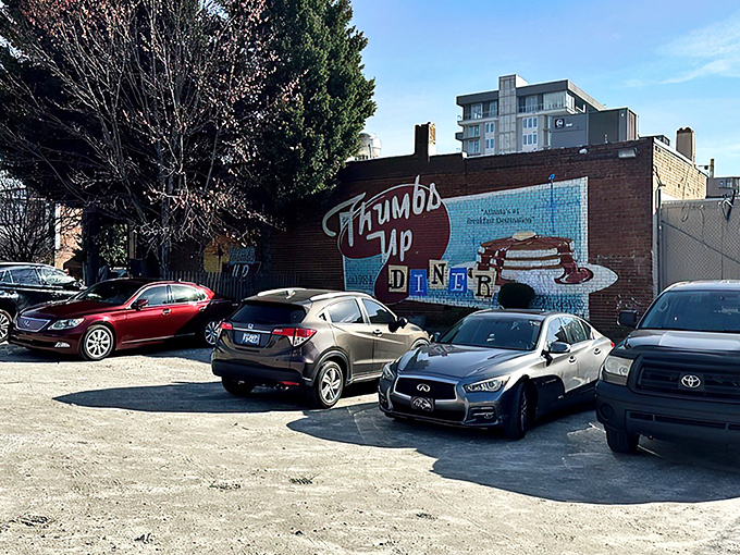 The iconic blue facade of Thumbs Up Diner promises "Breakfast Served All Day!" – words that should be carved into the Mount Rushmore of culinary comforts.