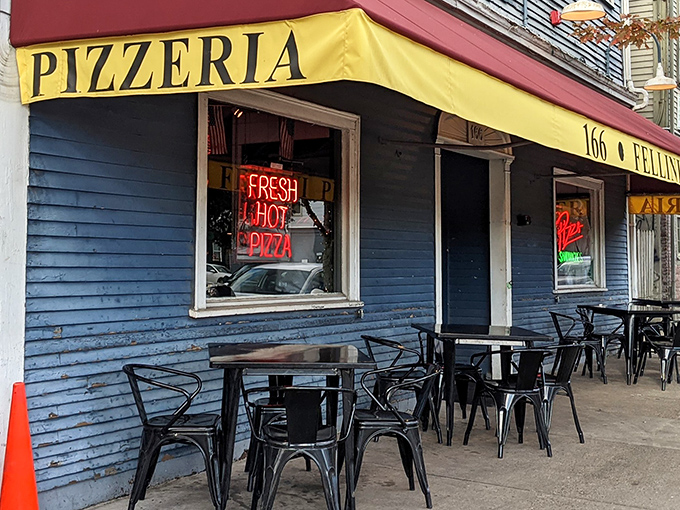 The bright yellow awning and neon "FRESH HOT PIZZA" sign beckon like an old friend on a chilly Providence evening. Outdoor seating awaits the brave during warmer months.