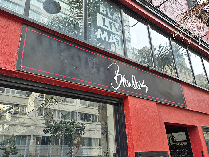 The vibrant red exterior of Brenda's beckons like a culinary lighthouse in San Francisco's Tenderloin, promising soulful delights within.